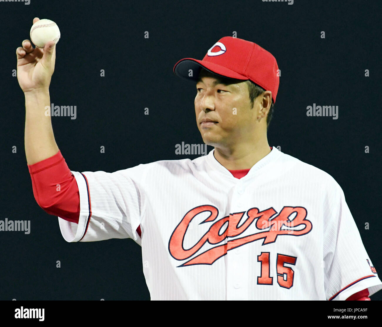 Hiroshima Carp pitcher Hiroki Kuroda shows the ball at Mazda Stadium in ...