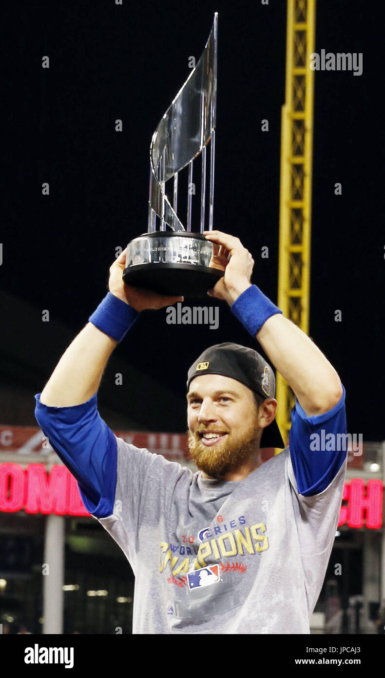 The Chicago Cubs' Ben Zobrist holds up the MVP trophy after his team ...