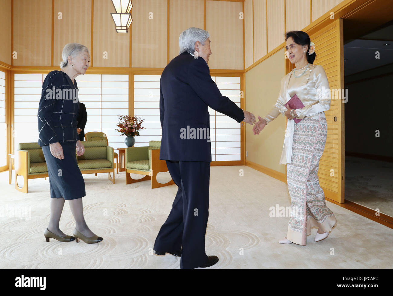 Myanmar leader Aung San Suu Kyi (R) meets with Japanese Emperor Akihito ...