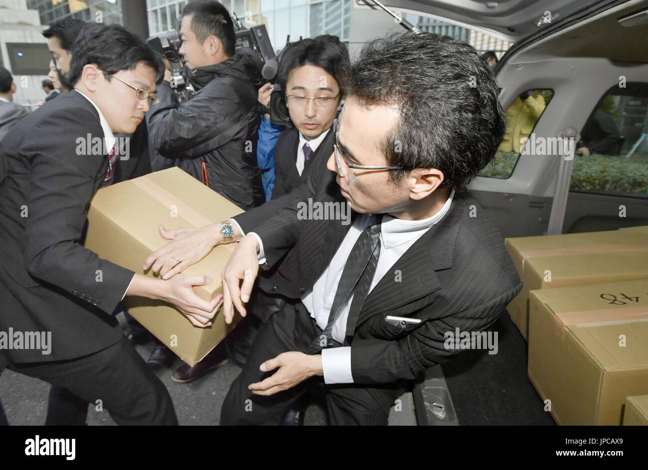 Labor authorities carry cardboard boxes into a car on Nov. 7, 2016 ...