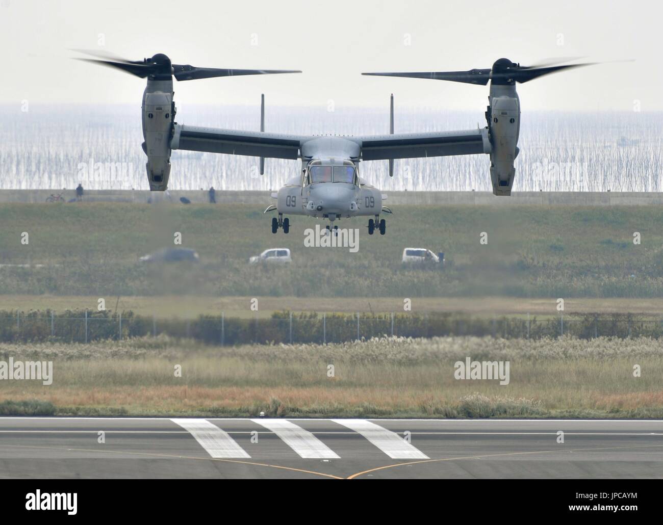 An Osprey tilt-rotor transport aircraft hovers above a runway at Saga ...