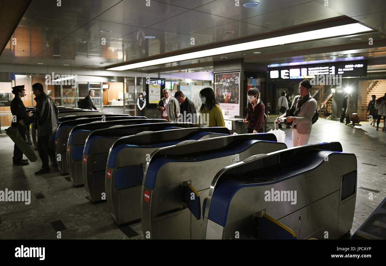 Train passengers go through ticket gates at a blackout-hit JR Hakata ...