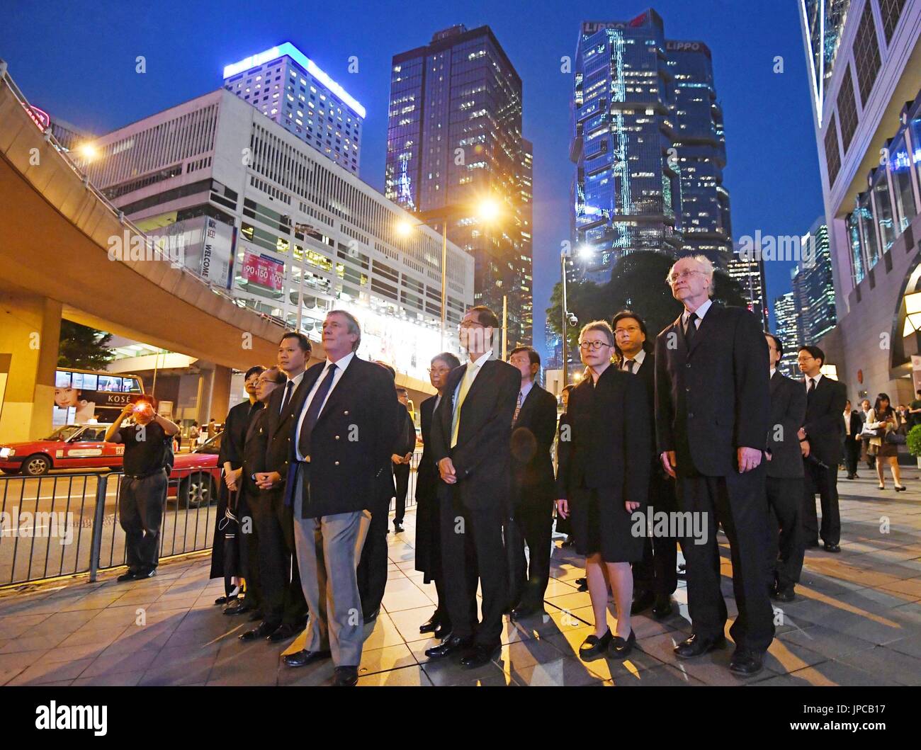 Lawyers and other people dressed in black suits and neckties march ...