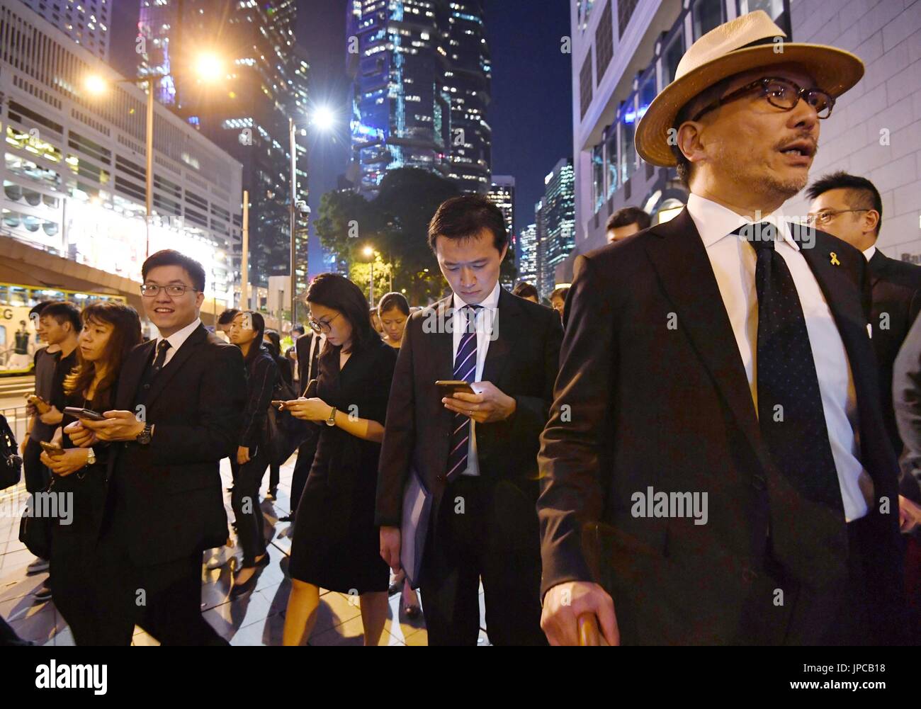 Lawyers and other people dressed in black suits and neckties march ...