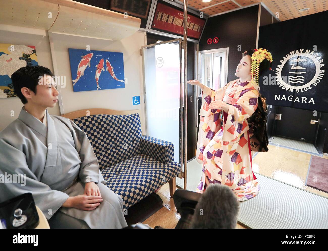 A geisha gives a preview of a dance performance inside a train carriage ...