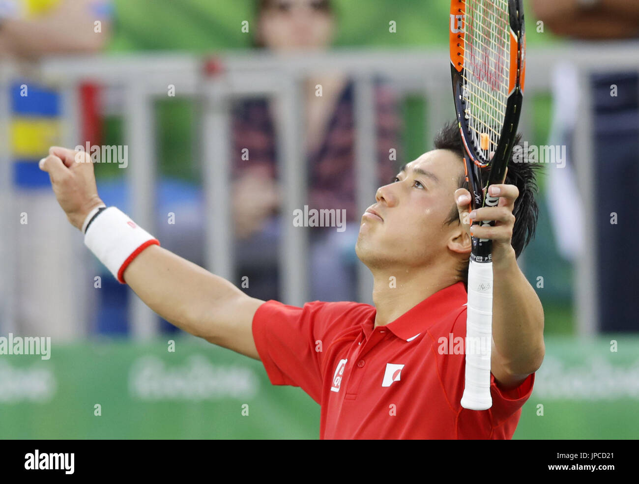 Kei Nishikori of Japan celebrates his victory in the bronze-medal match ...