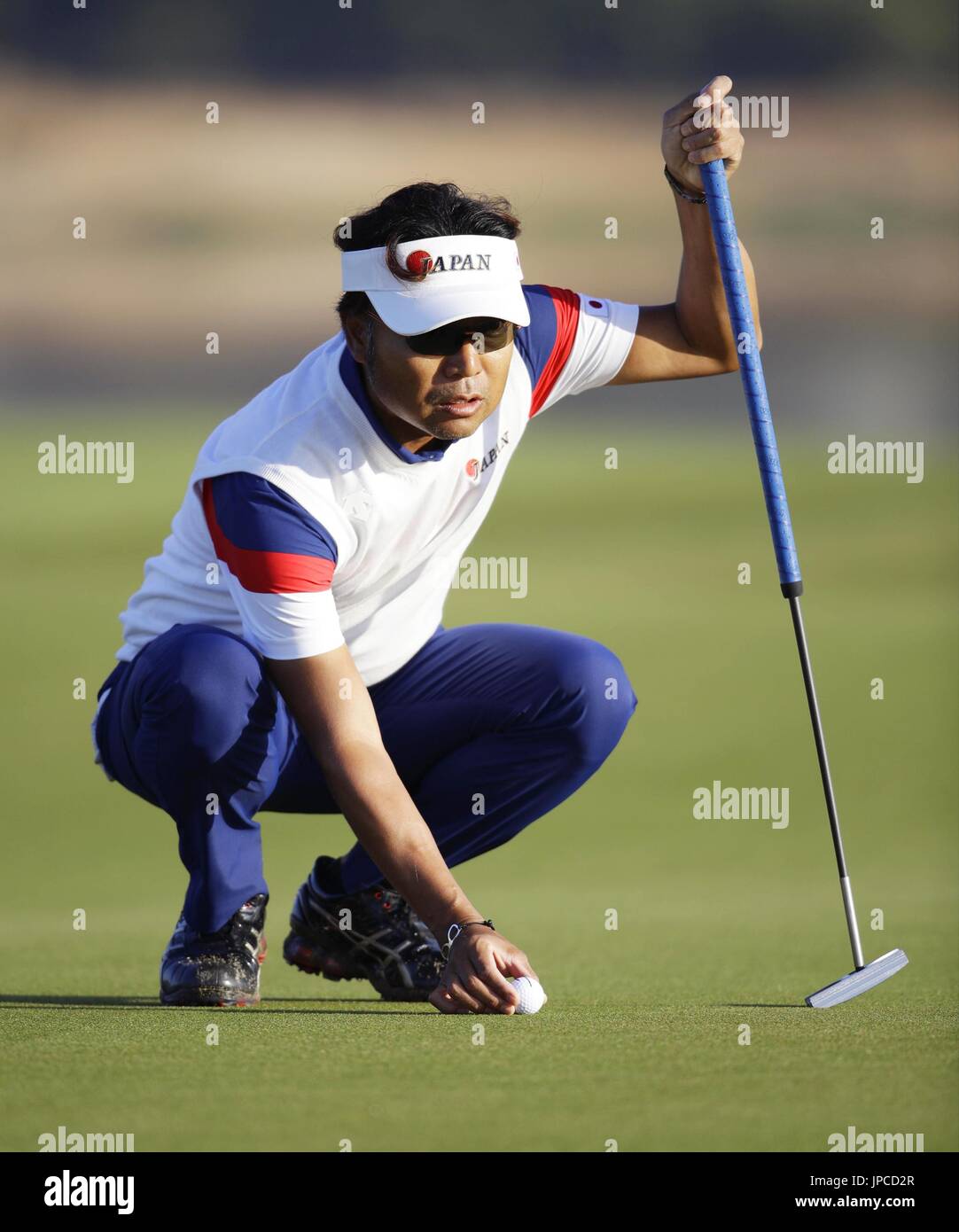 Japan's Shingo Katayama reads a putting line on the third green during ...