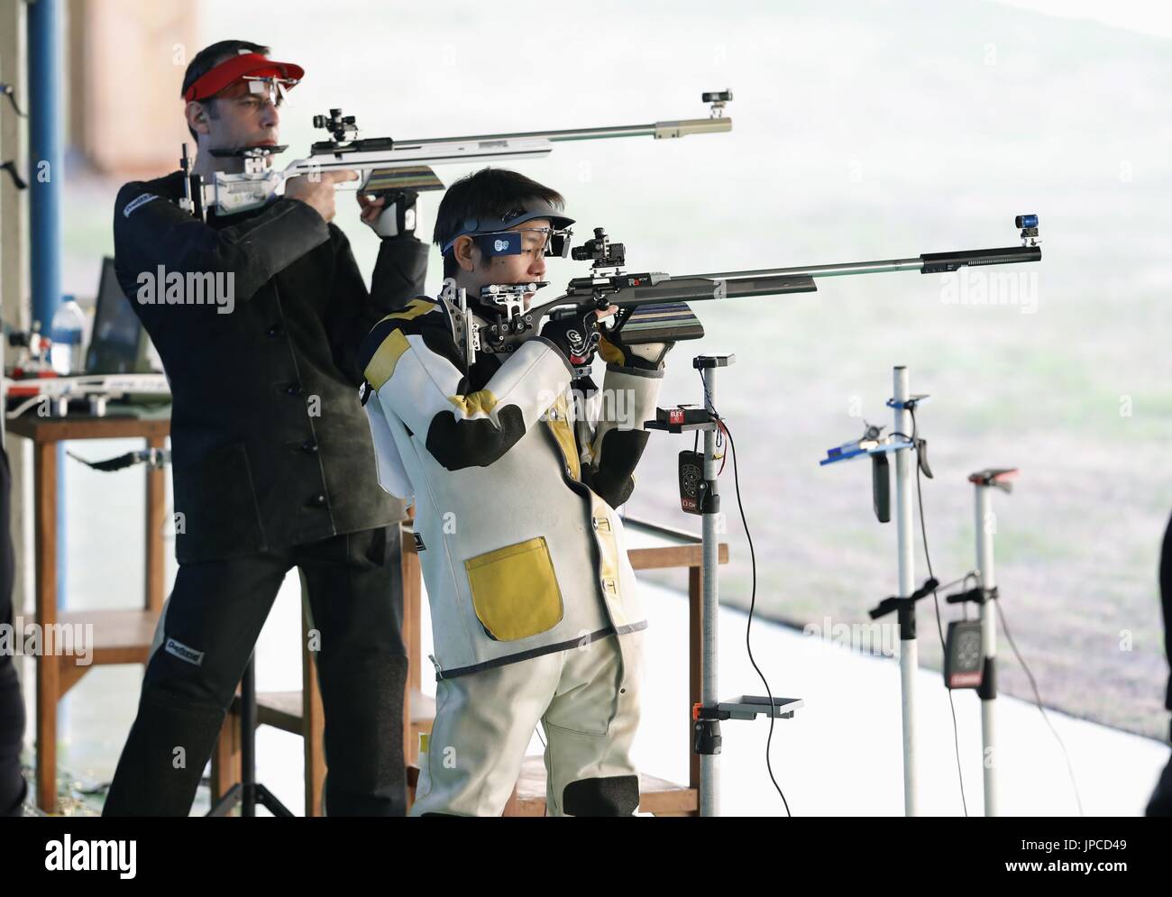 Japan's Toshikazu Yamashita (2nd from L) shoots from a standing ...