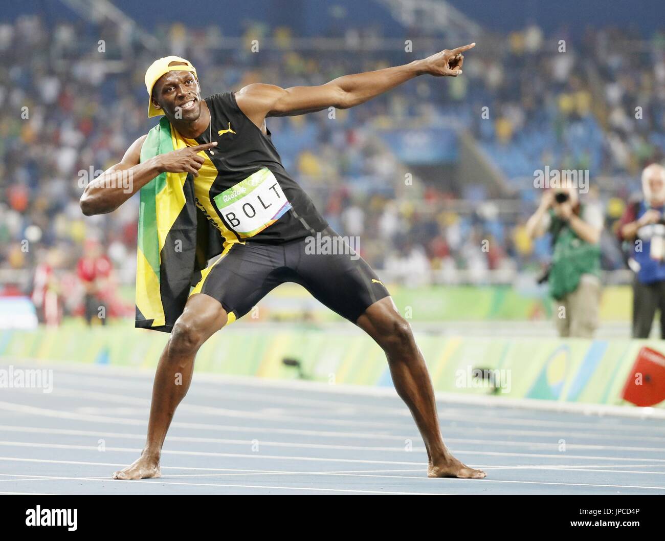 Usain Bolt of Jamaica strikes his trademark "Lightning Bolt" pose after winning the men's 100 ...
