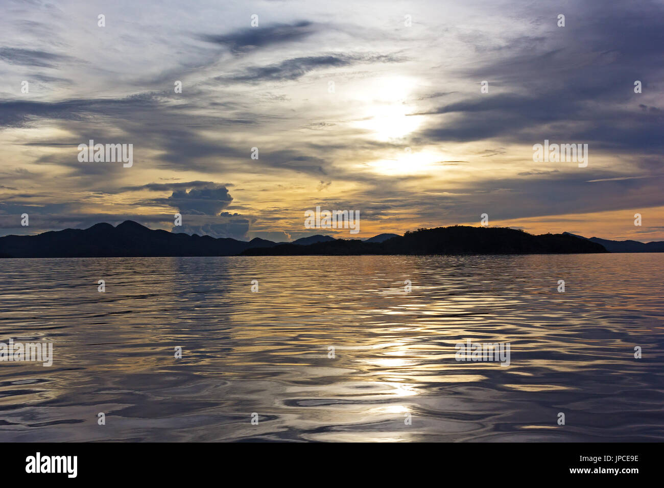 Sunset over the mountains on the horizon on Coron Island, Philippines ...