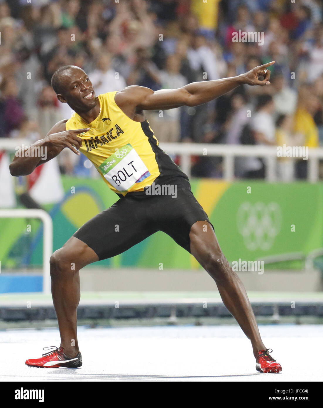 Usain Bolt of Jamaica strikes his signature "Lightning Bolt" pose after ...