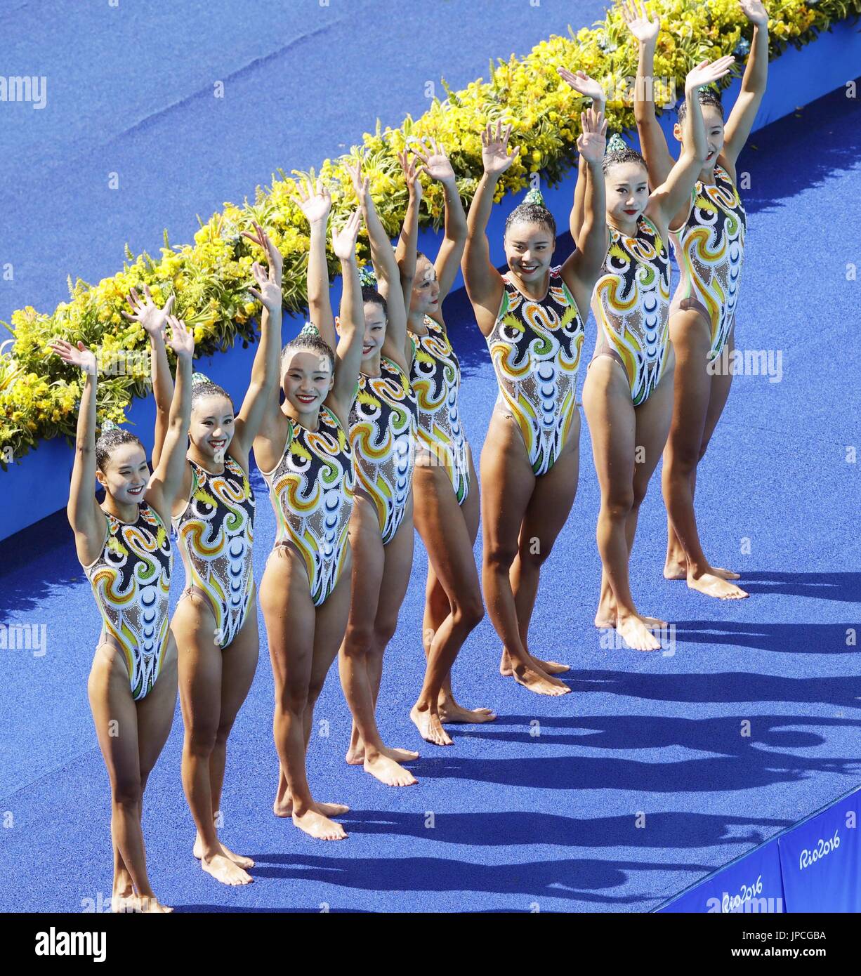 China's synchronized swimming team members wave to the crowd after ...
