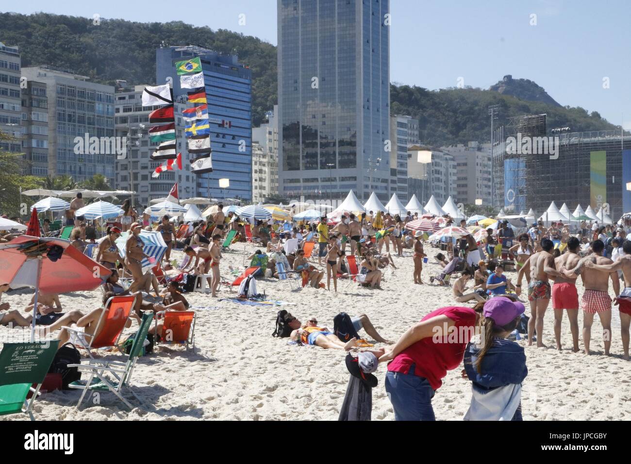Beachgoers soak up the rays on Copacabana beach, the site of the beach ...