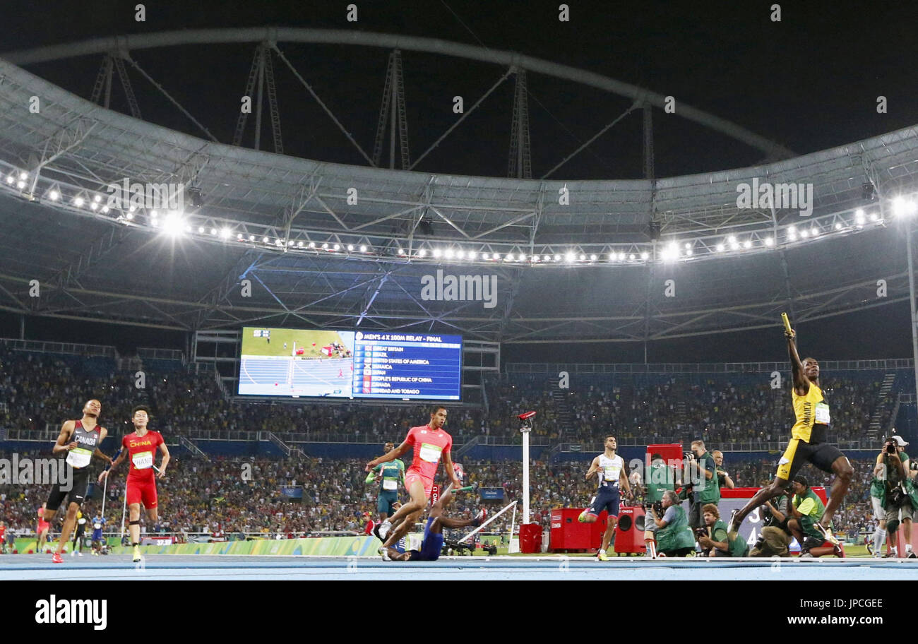 Runners cross the finish line in the men's 4x100-meter relay final ...