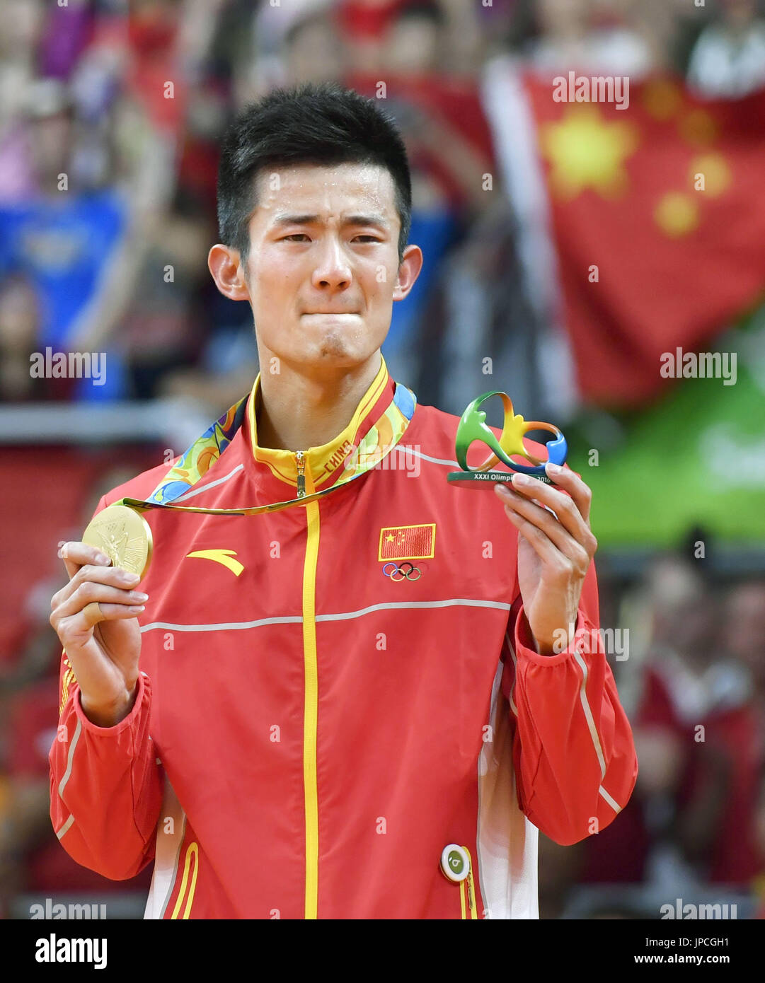 Chinese badminton player Chen Long cries at the medal ceremony after ...