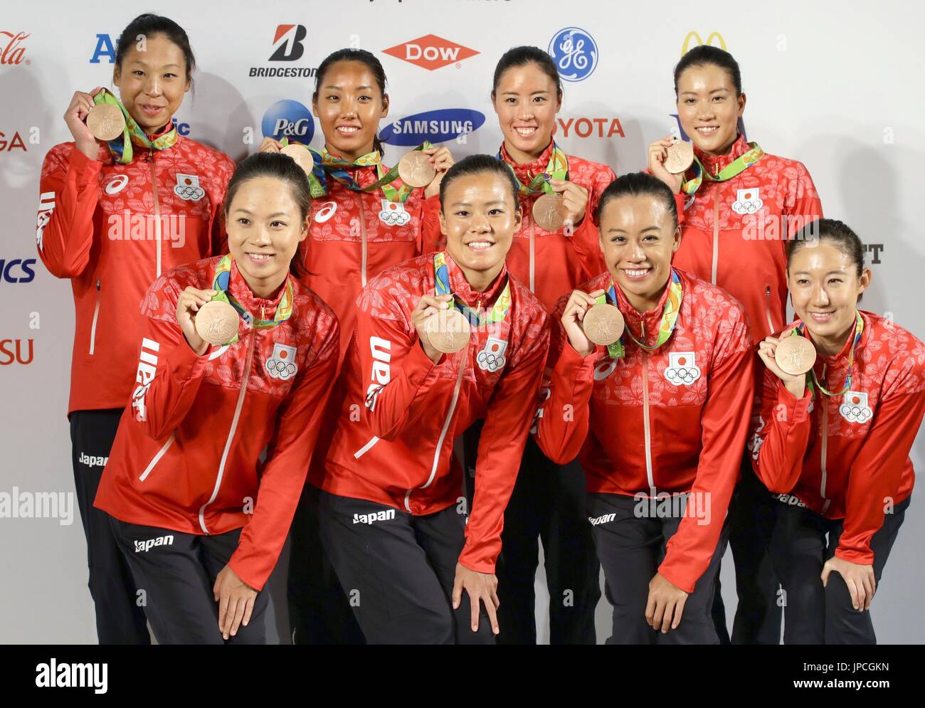 Members of Japan's synchronized swimming team pose for a photo at a ...