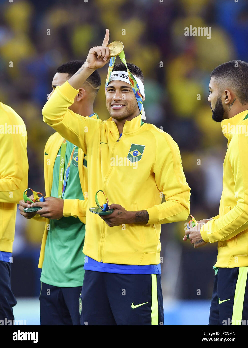 Neymar (C) holds up his gold medal during the award ceremony for the ...