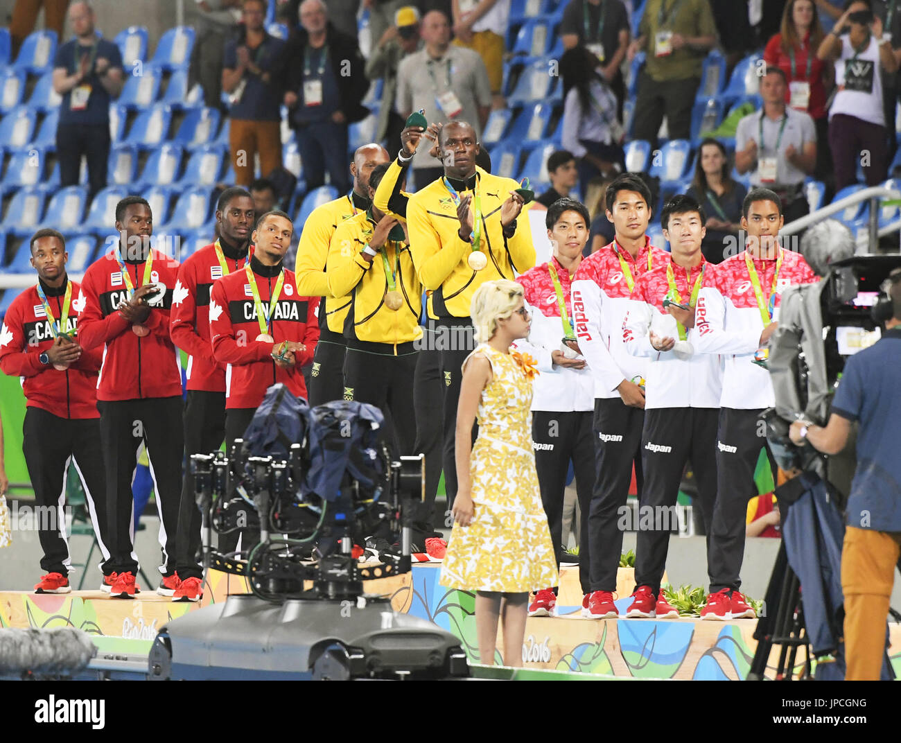 The men's 4x100-meter relay team members of Jamaica (C), Japan (front ...