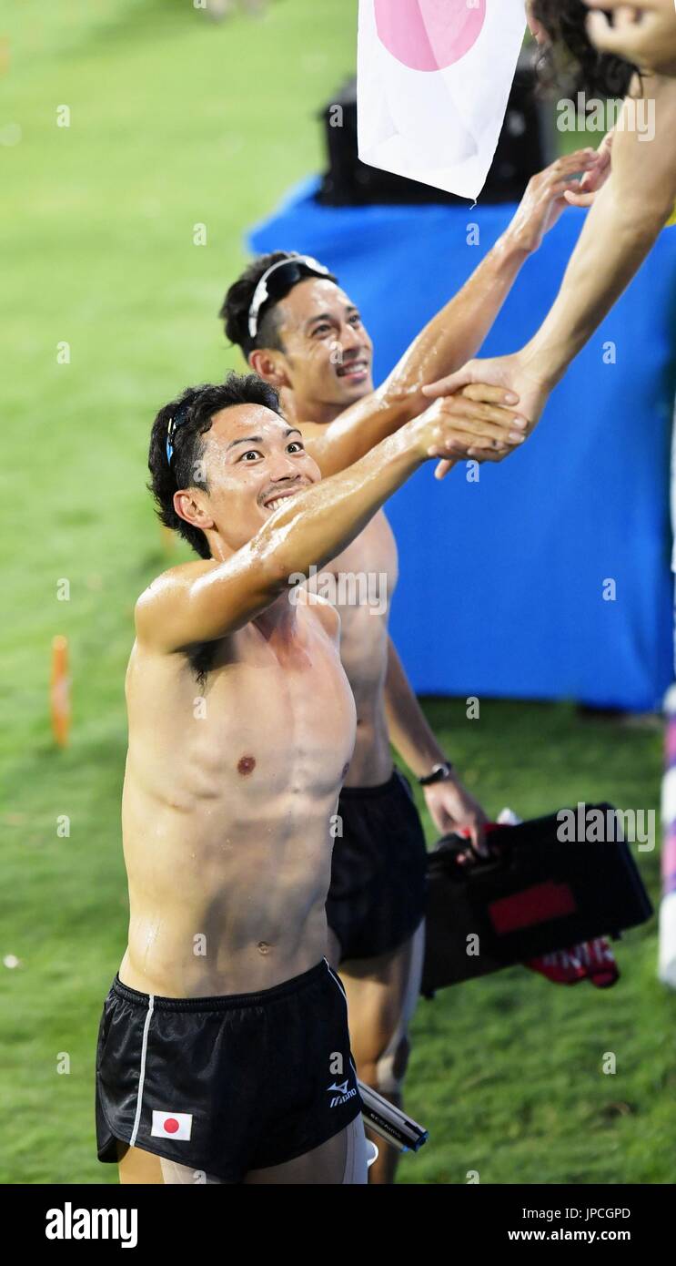 Japan's Shohei Iwamoto (front) and Tomoya Miguchi shake fans with fans after completing in the ...