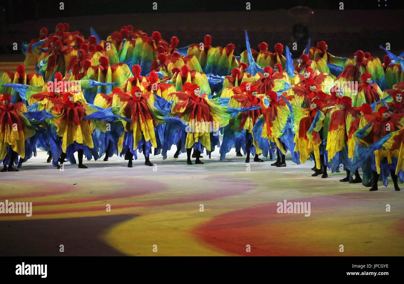 Dancers wearing colorful costumes perform during the closing ceremony ...