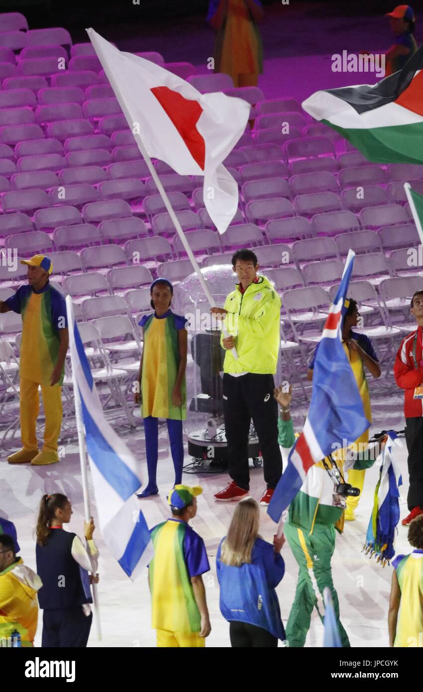 Decathlete Keisuke Ushiro (C) carries the Japanese flag during the ...