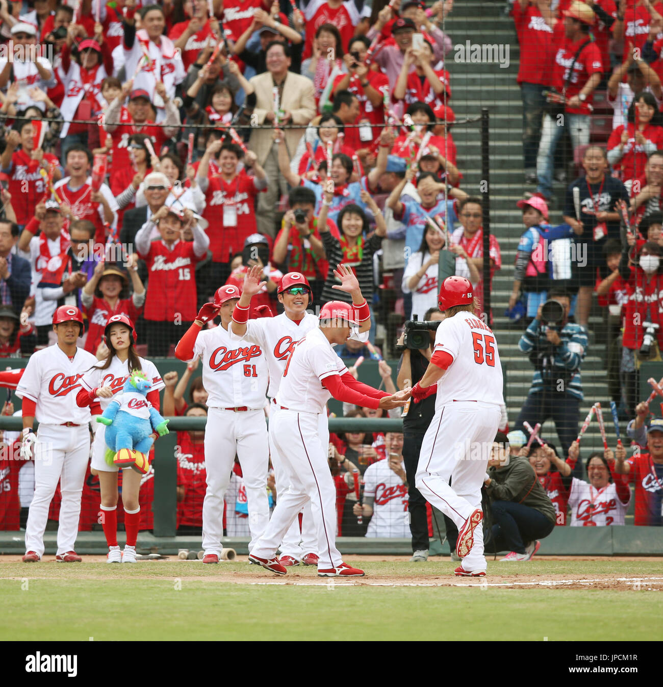 Hiroshima Carp players and fans celebrate as Brad Eldred (55) hits a ...