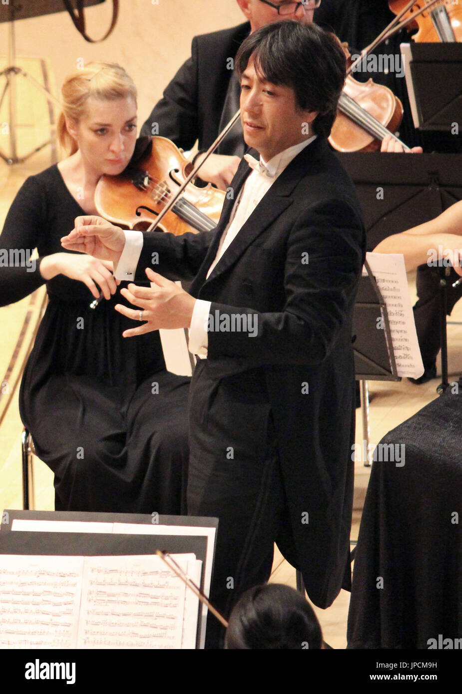 Japanese conductor Toshio Yanagisawa directs the multiethnic Balkan ...