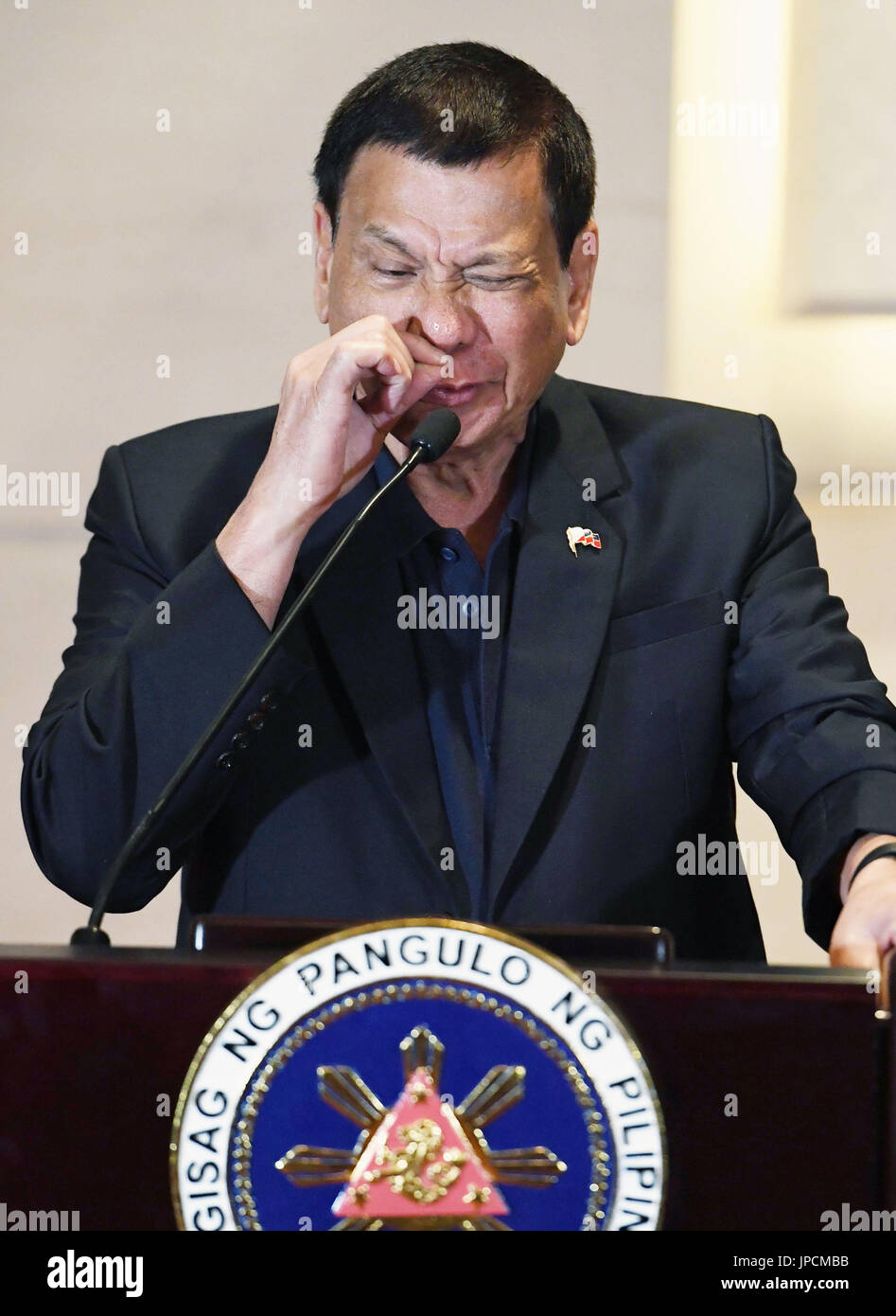 Philippine President Rodrigo Duterte rubs his nose during a press ...