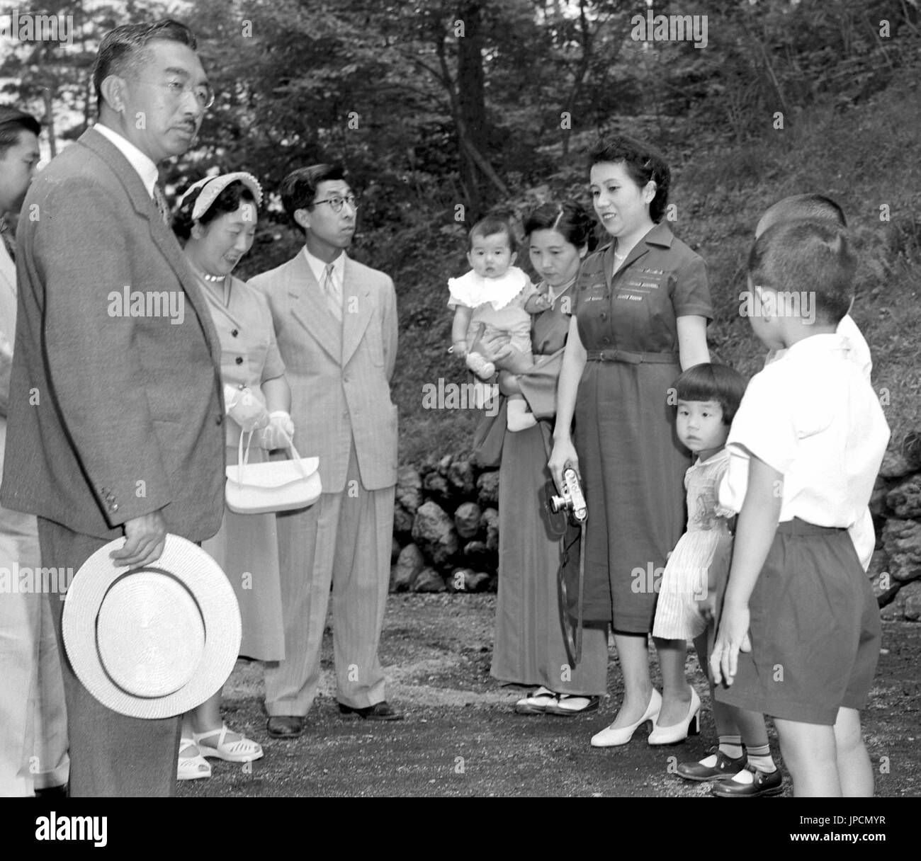 Prince Mikasa (3rd from L) and his wife Princess Yuriko (holding camera ...