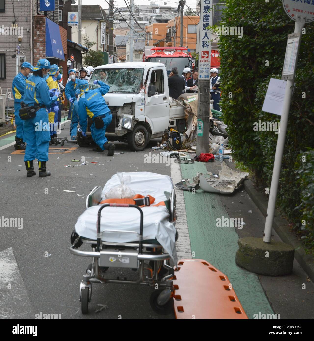 Police officers examine an accident scene in Yokohama, near Tokyo, on ...