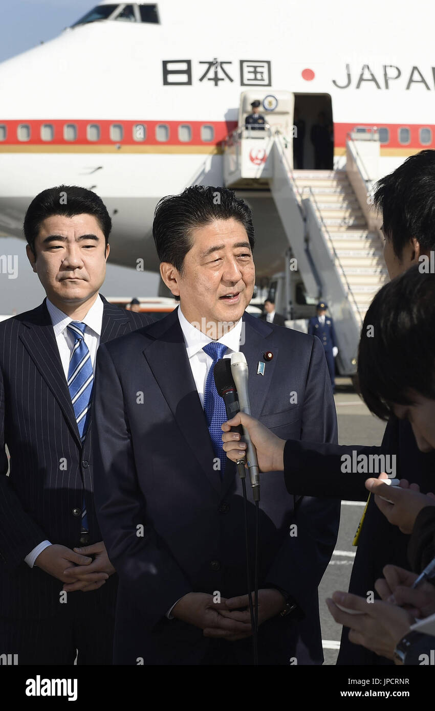 Prime Minister Shinzo Abe meets with reporters at Tokyo's Haneda ...