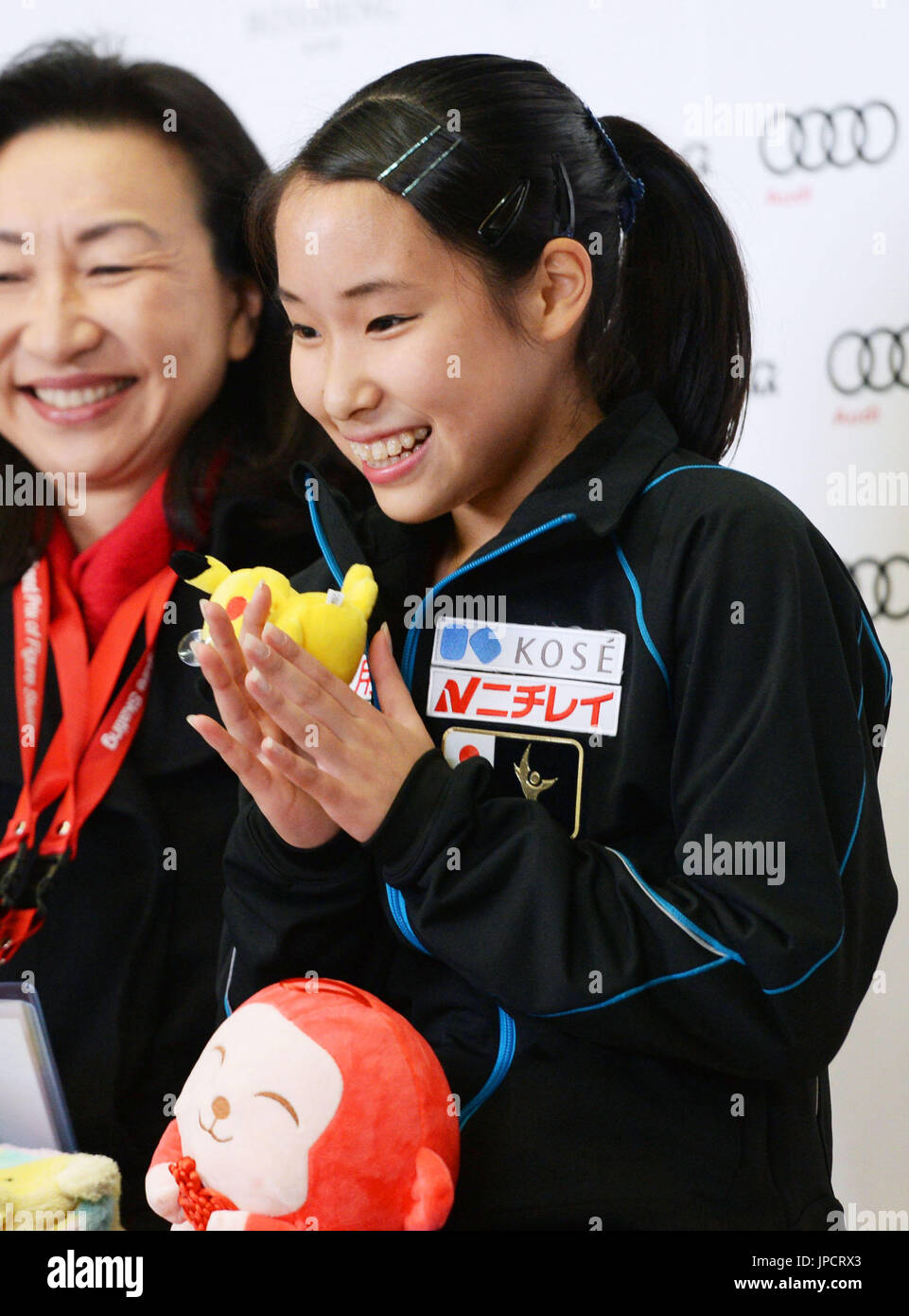 Japanese figure skater Mai Mihara (R) reacts after receiving a personal ...