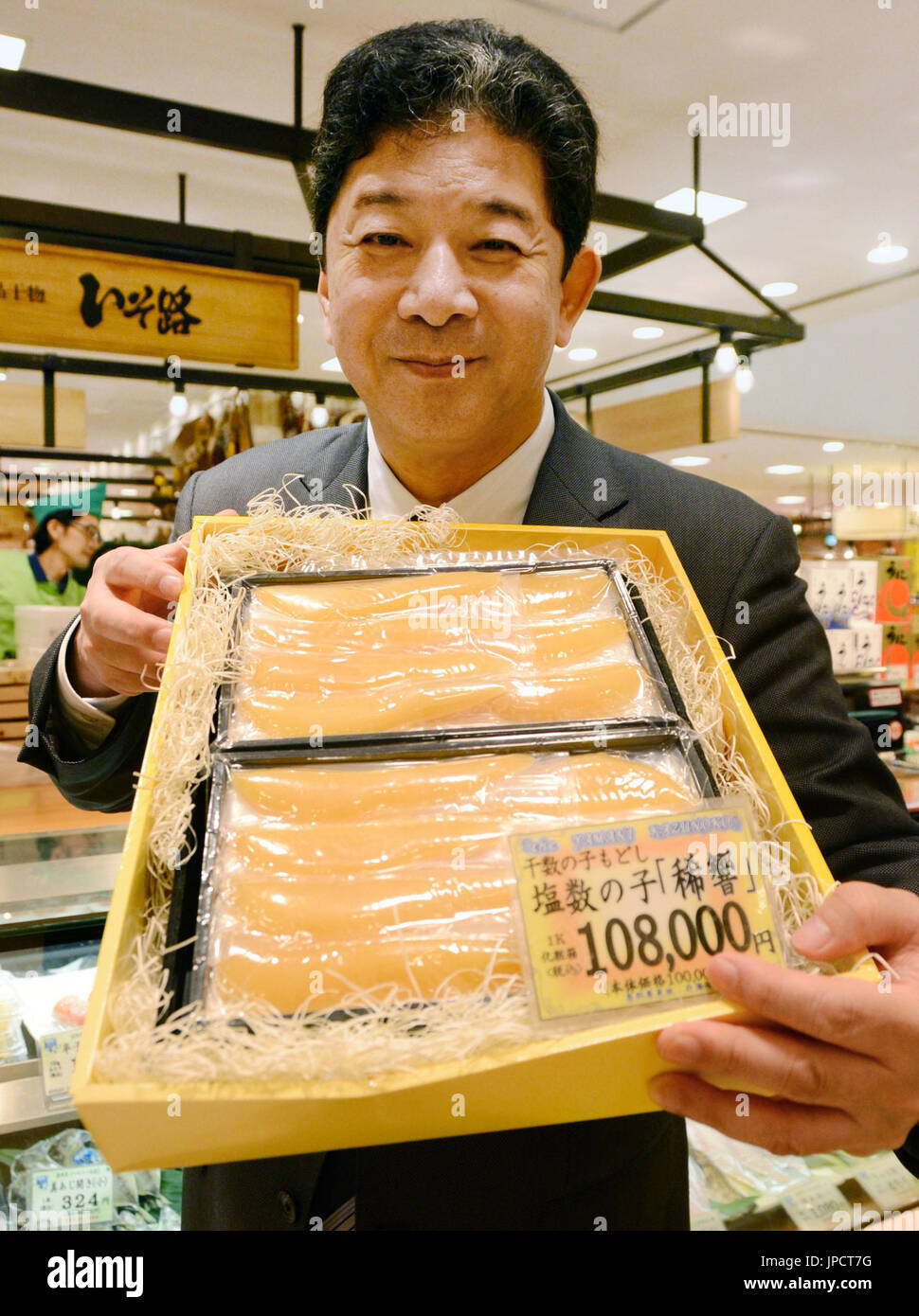 A man holds up a package of a rare selection of salted herring roe ...