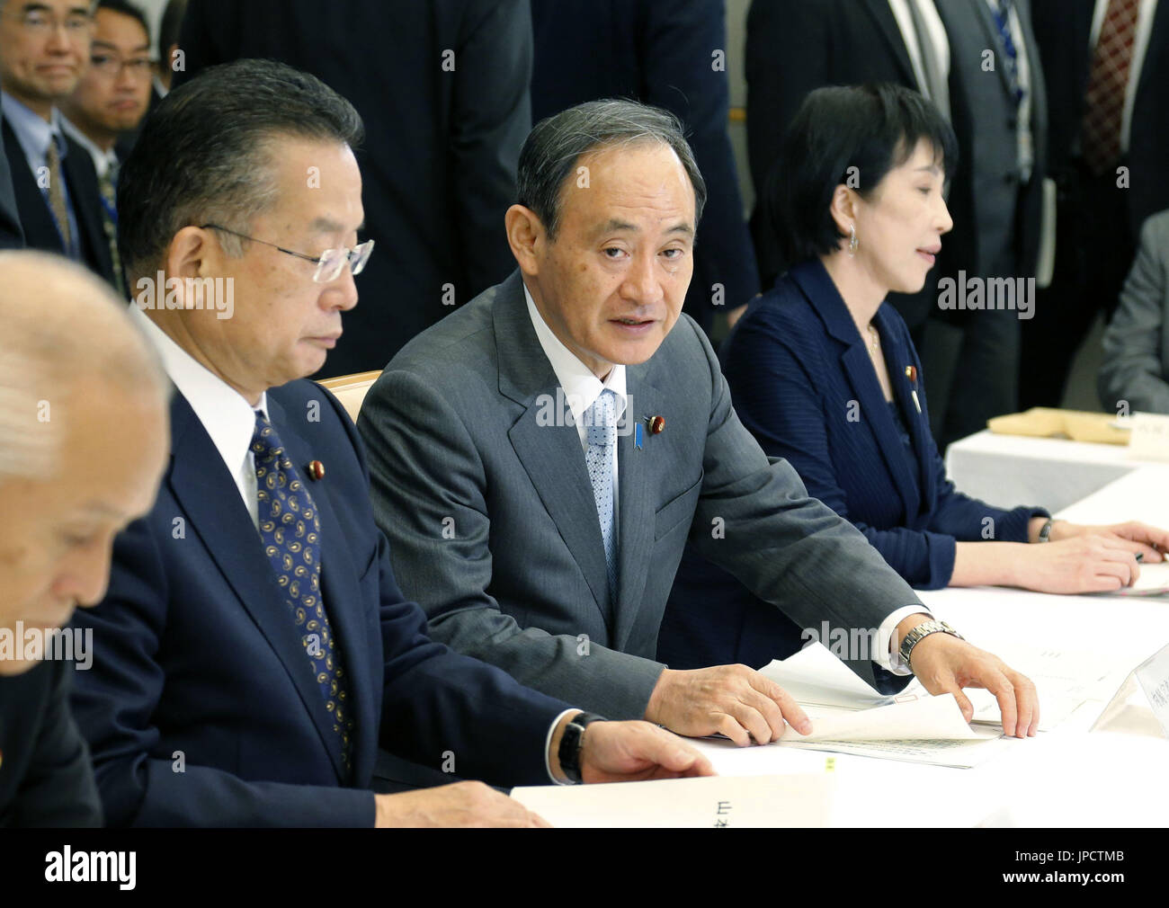 Japanese Chief Cabinet Secretary Yoshihide Suga (2nd from R) attends a ...