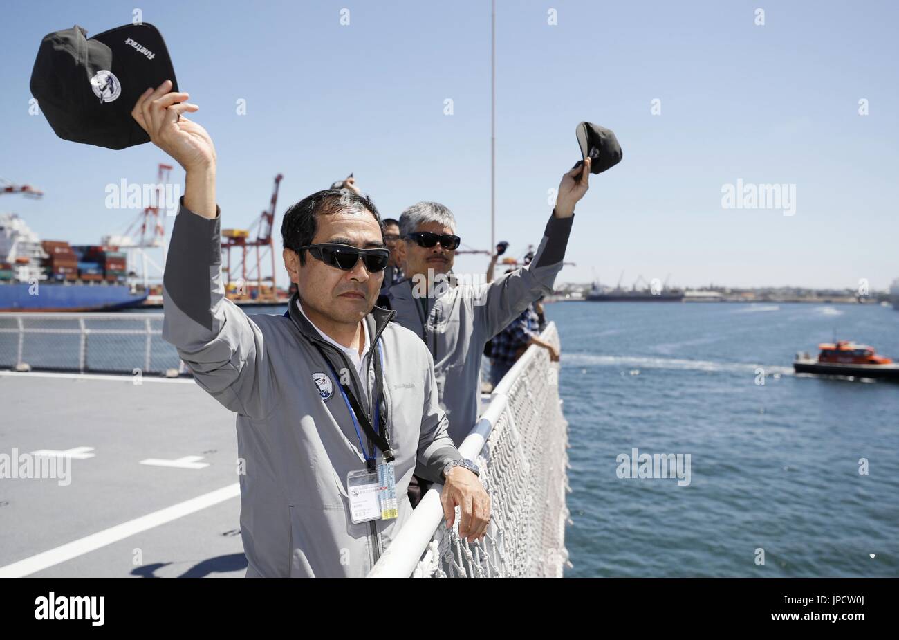 Crew members of the Japanese icebreaker Shirase wave to well-wishers in ...
