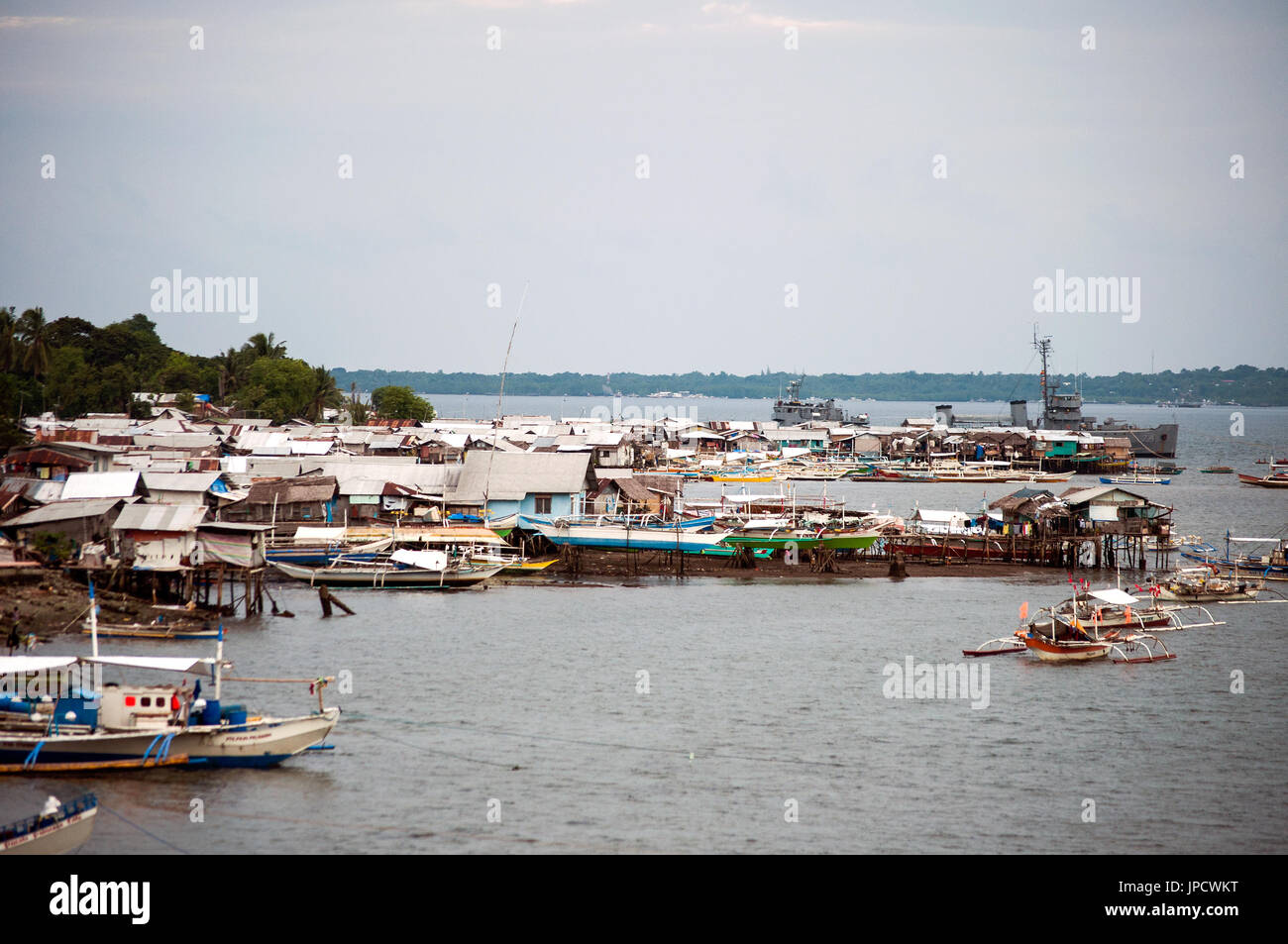 Aerial view of fishing boats and stilt fishing village near port ...