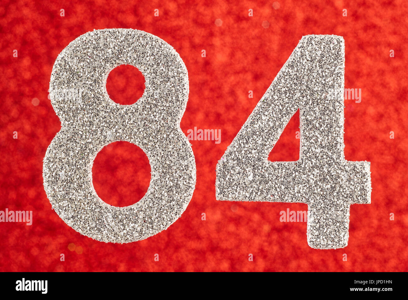 Number eighty-four silver color over a red background. Anniversary ...