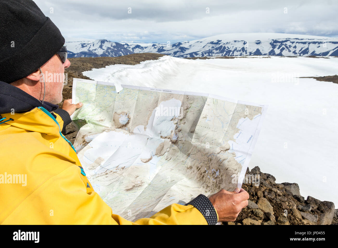 Man with map exploring wilderness on trekking adventure Stock Photo - Alamy