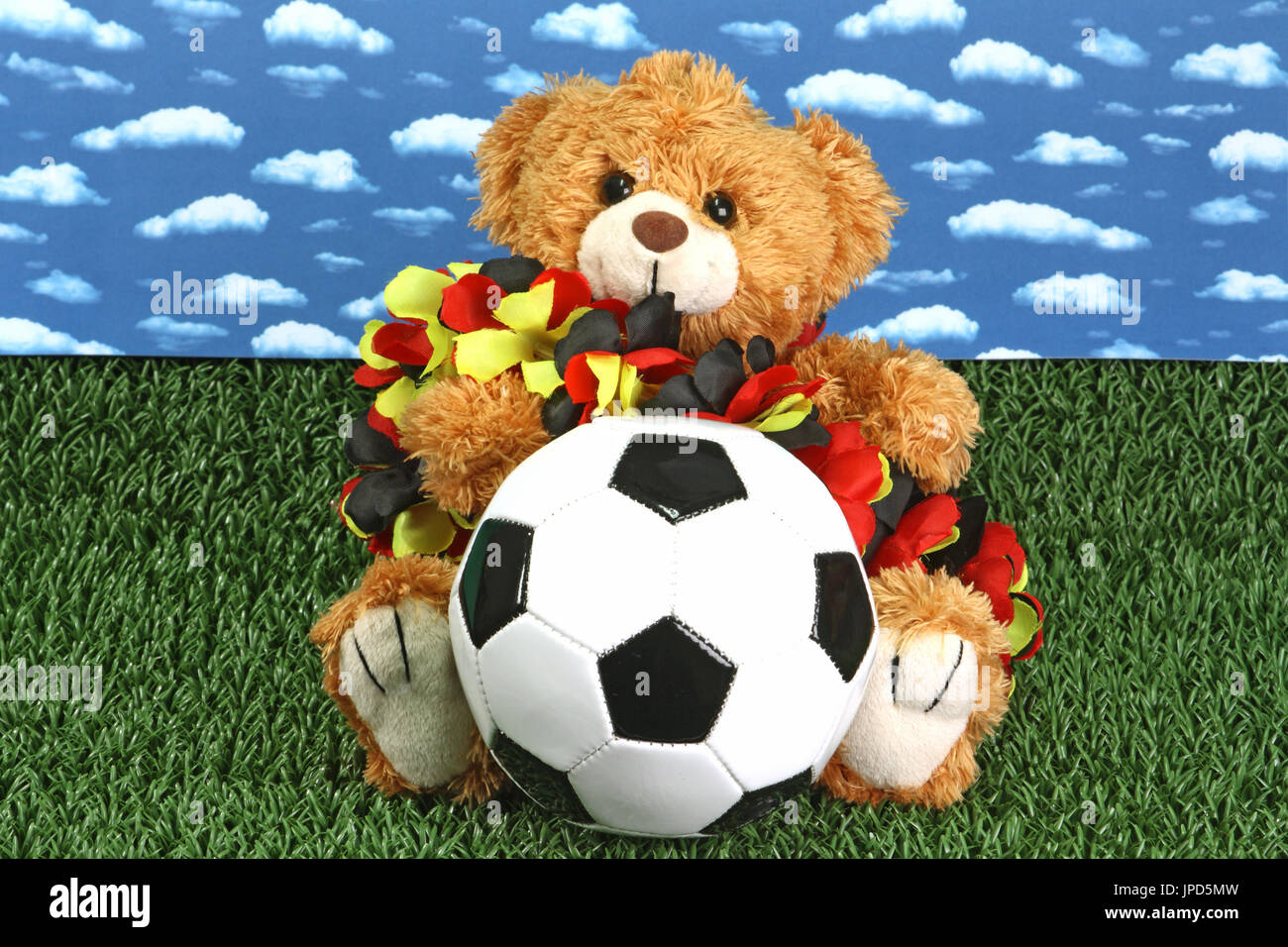 Cute teddy bear with a soccerball onb right background Stock Photo - Alamy