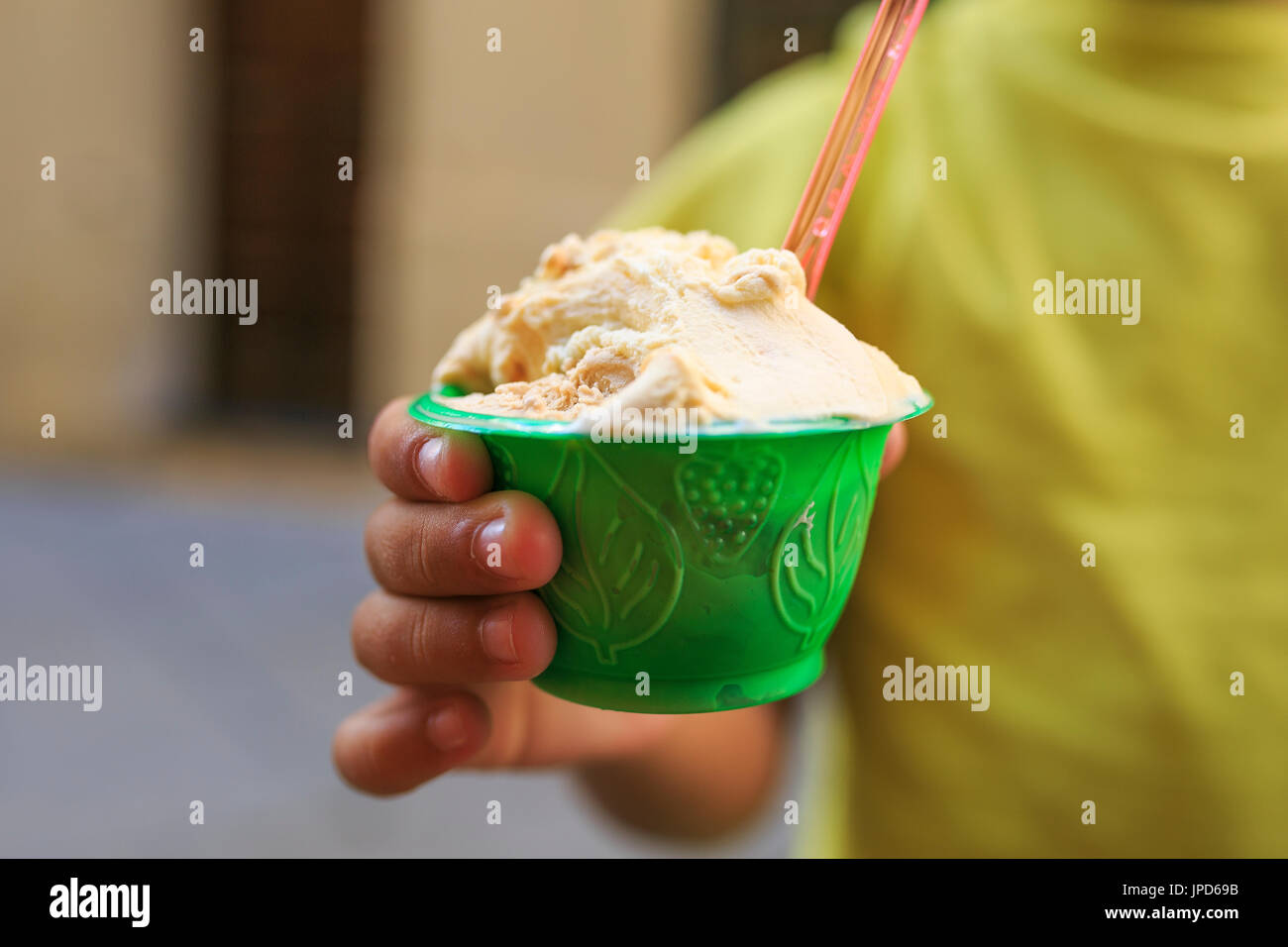 Boy eating ice cream on the street Stock Photo - Alamy