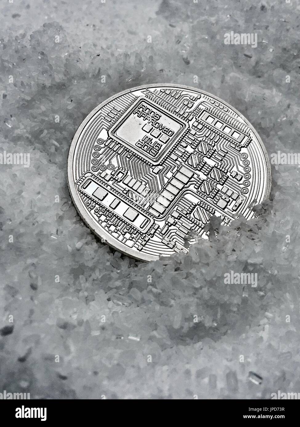 Digital currency physical metal coin on the white cristal background ...