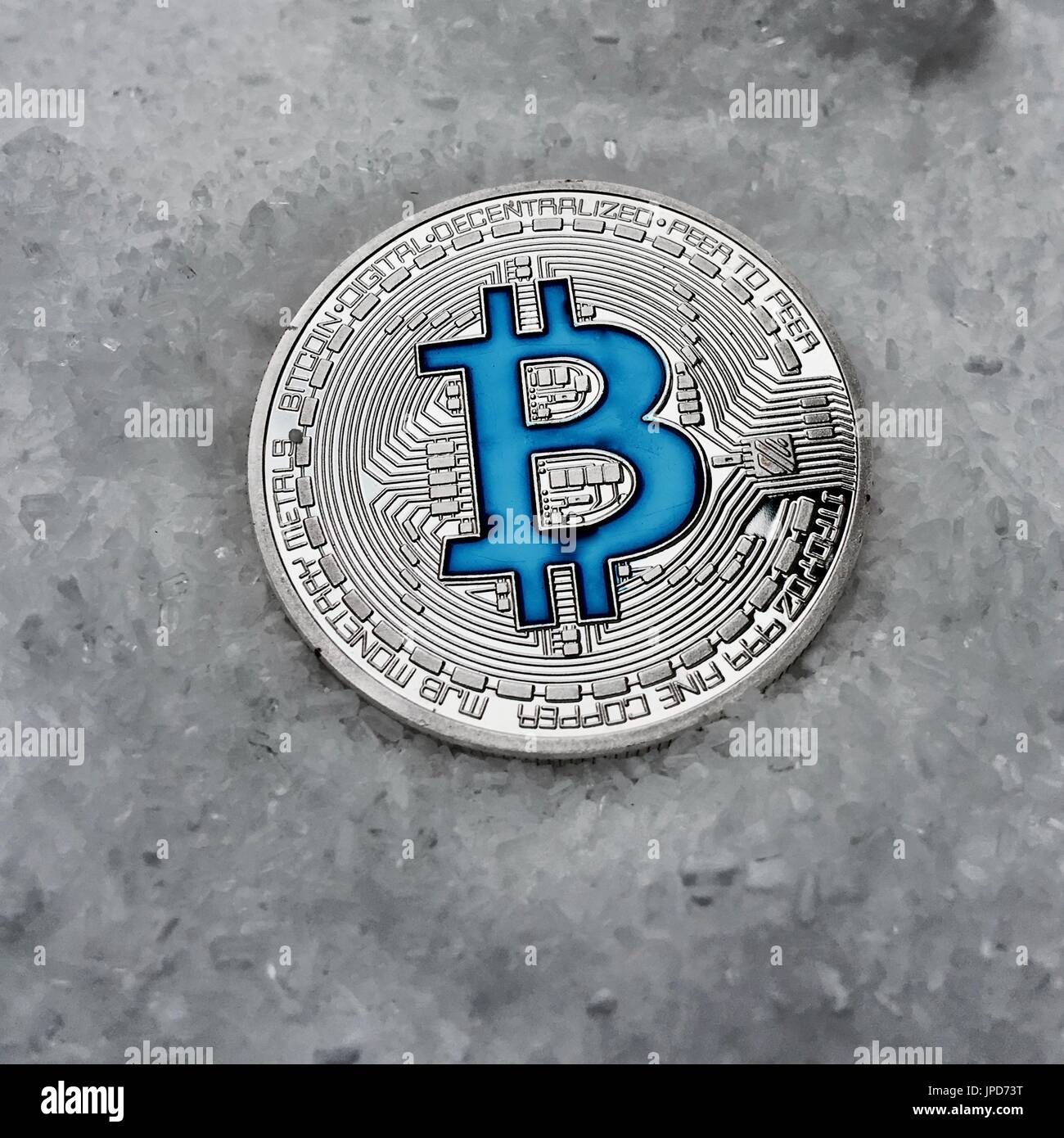 Digital currency physical metal coin on the white cristal background ...
