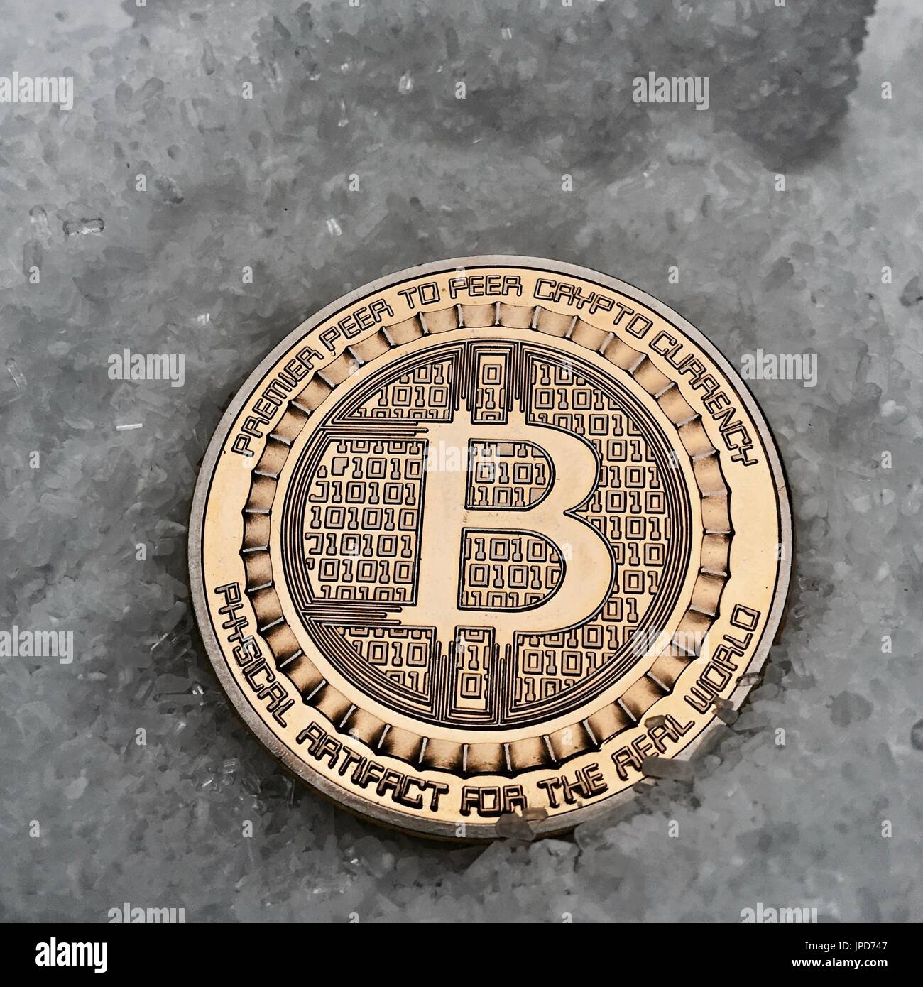 Digital currency physical metal coin on the white cristal background ...