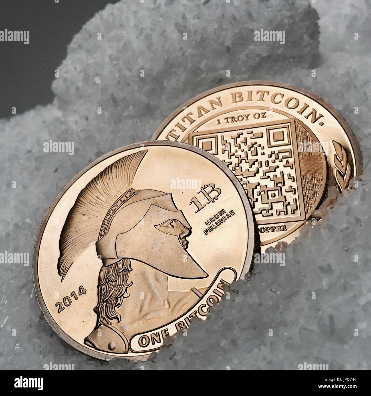 Digital currency physical metal coin on the white cristal background ...