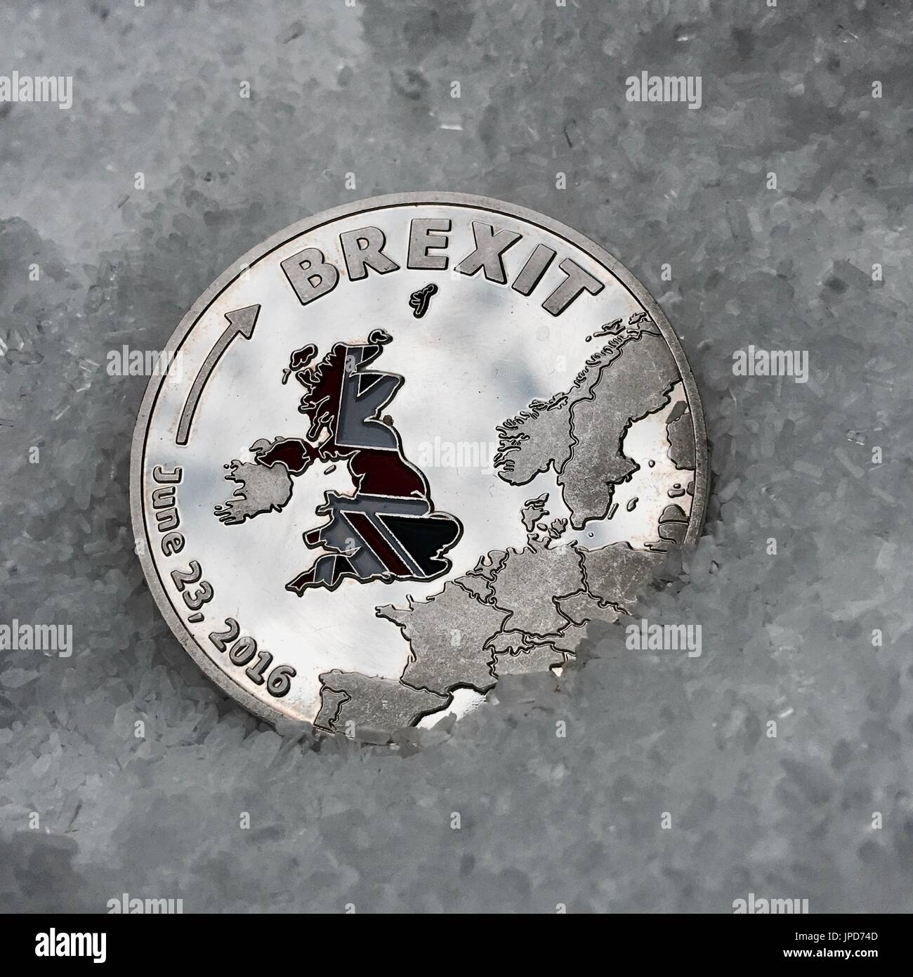 Europe leaving. Silver brexit coin with british map on the salt Stock ...