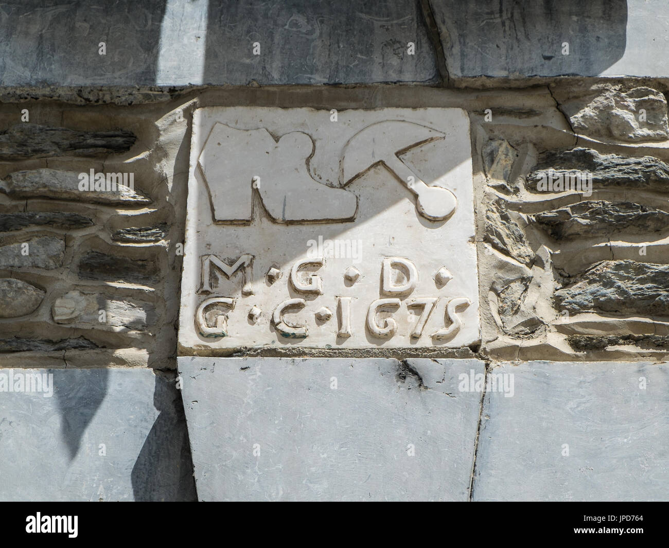 Old stone carved sign for cobbler, Laruns, Pyrénées-Atlantiques, France ...