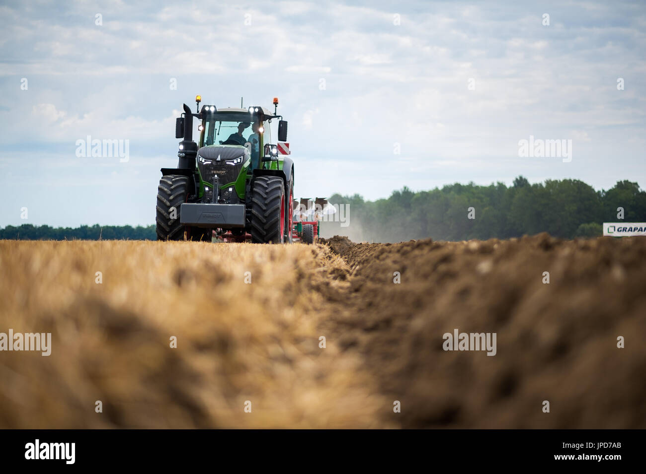 Fendt tractor plowing earth on country fair Stock Photo - Alamy