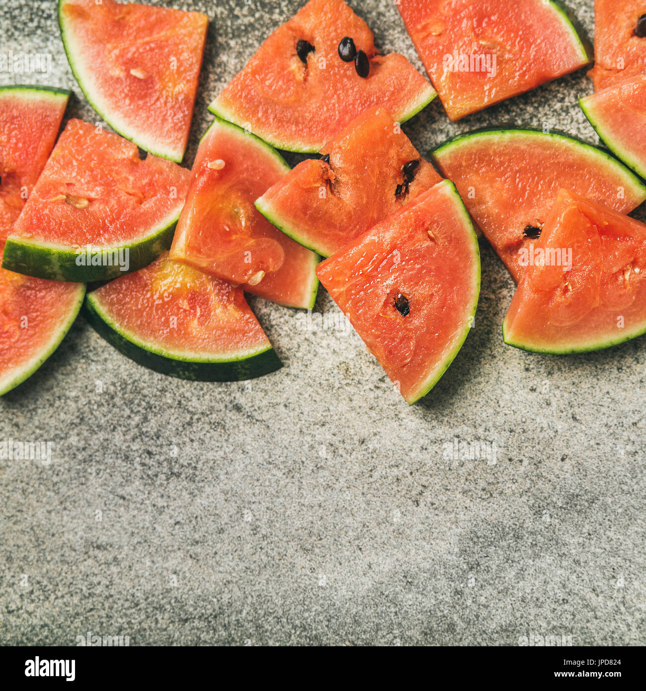 Juicy watermelon pieces over concrete stone background, square crop ...