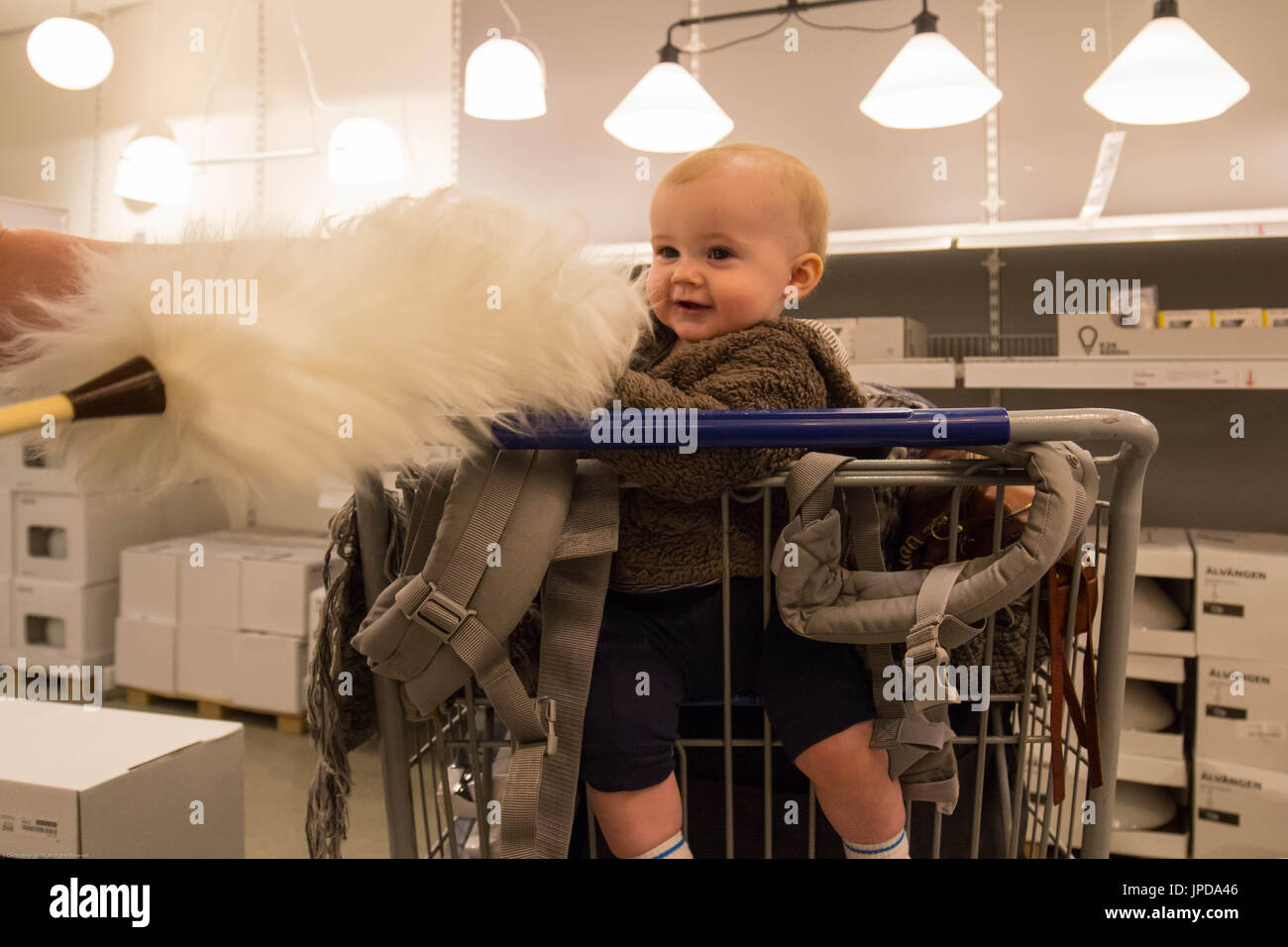 baby tickled by fluffy duster Stock Photo - Alamy