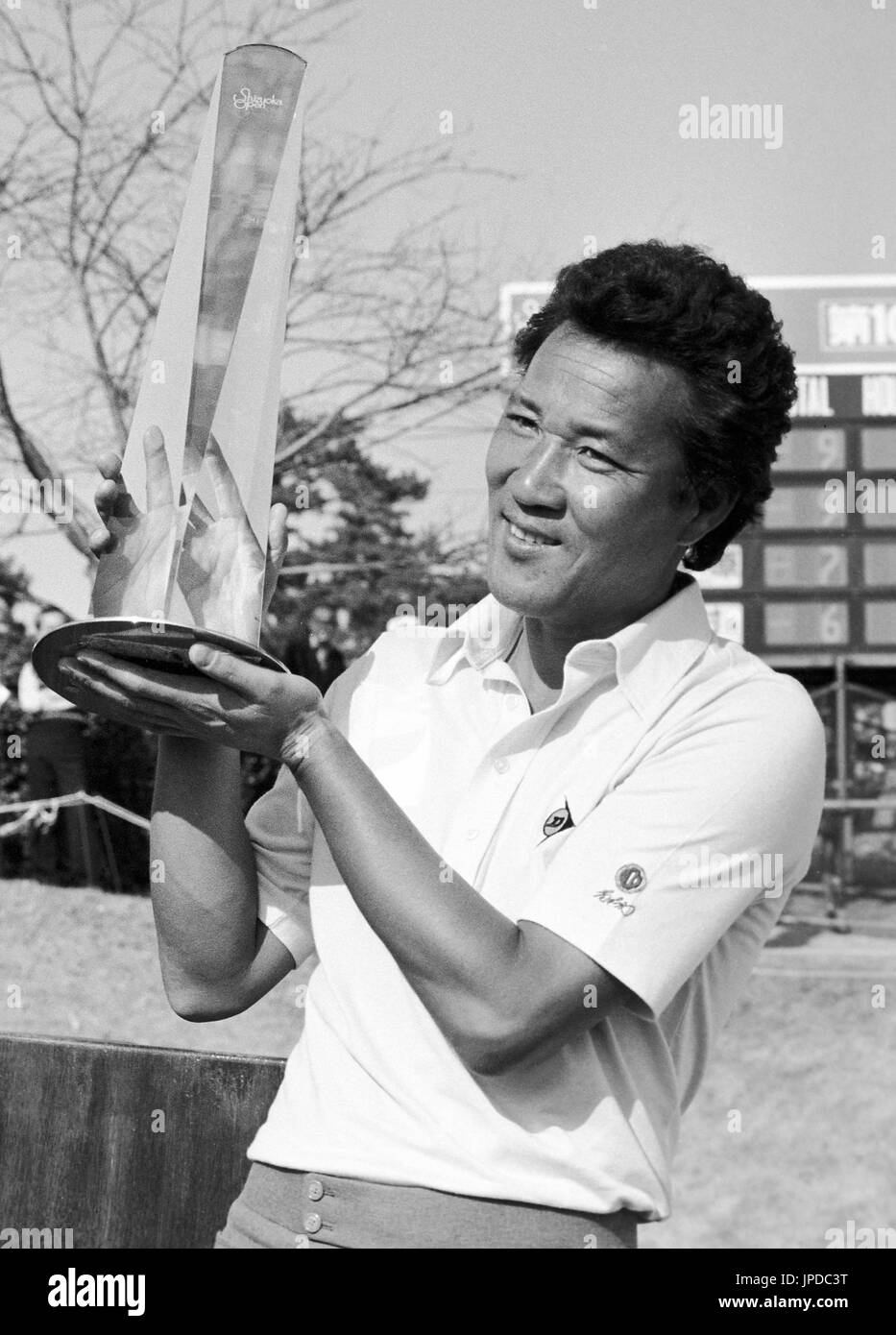 Japanese golfer Isao Aoki holds the winner's trophy of the Shizuoka ...